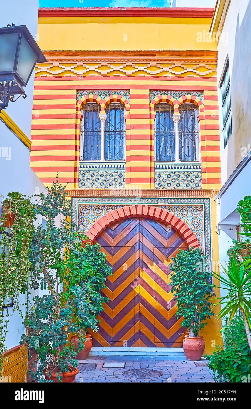 The gate of historic Mudejar mansion with zigzag pattern, tile door ...