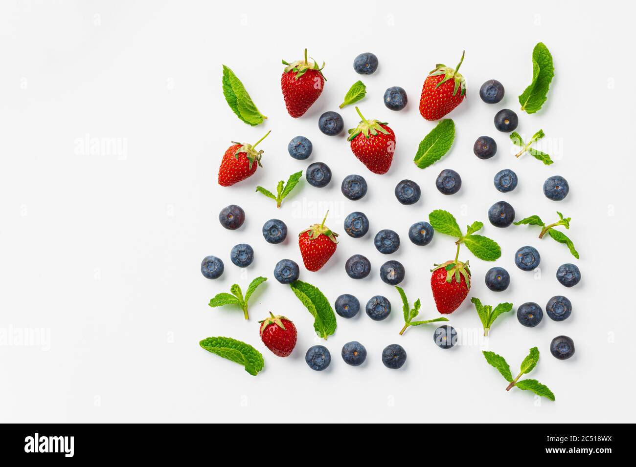 Strawberries and blueberries scattered on white background Stock Photo ...
