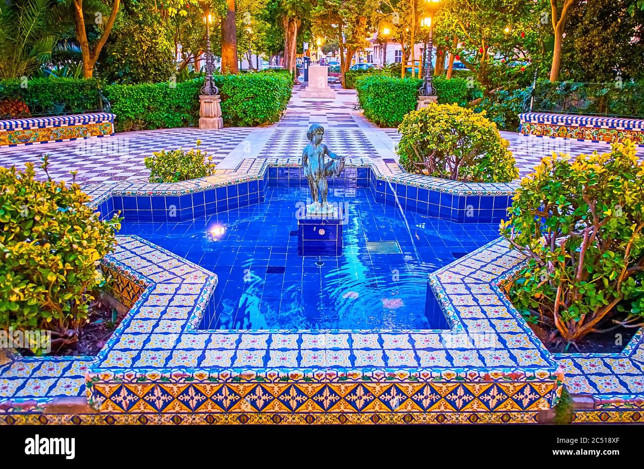 The small fountain, surrounded with Andalusian style tilling among the ...