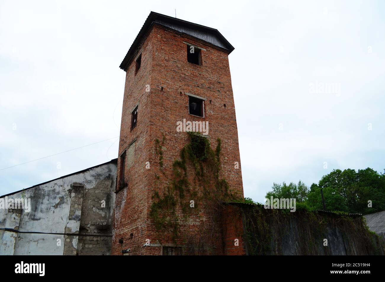 A wall of an old abandoned brick building with broken windows Stock Photo - Alamy