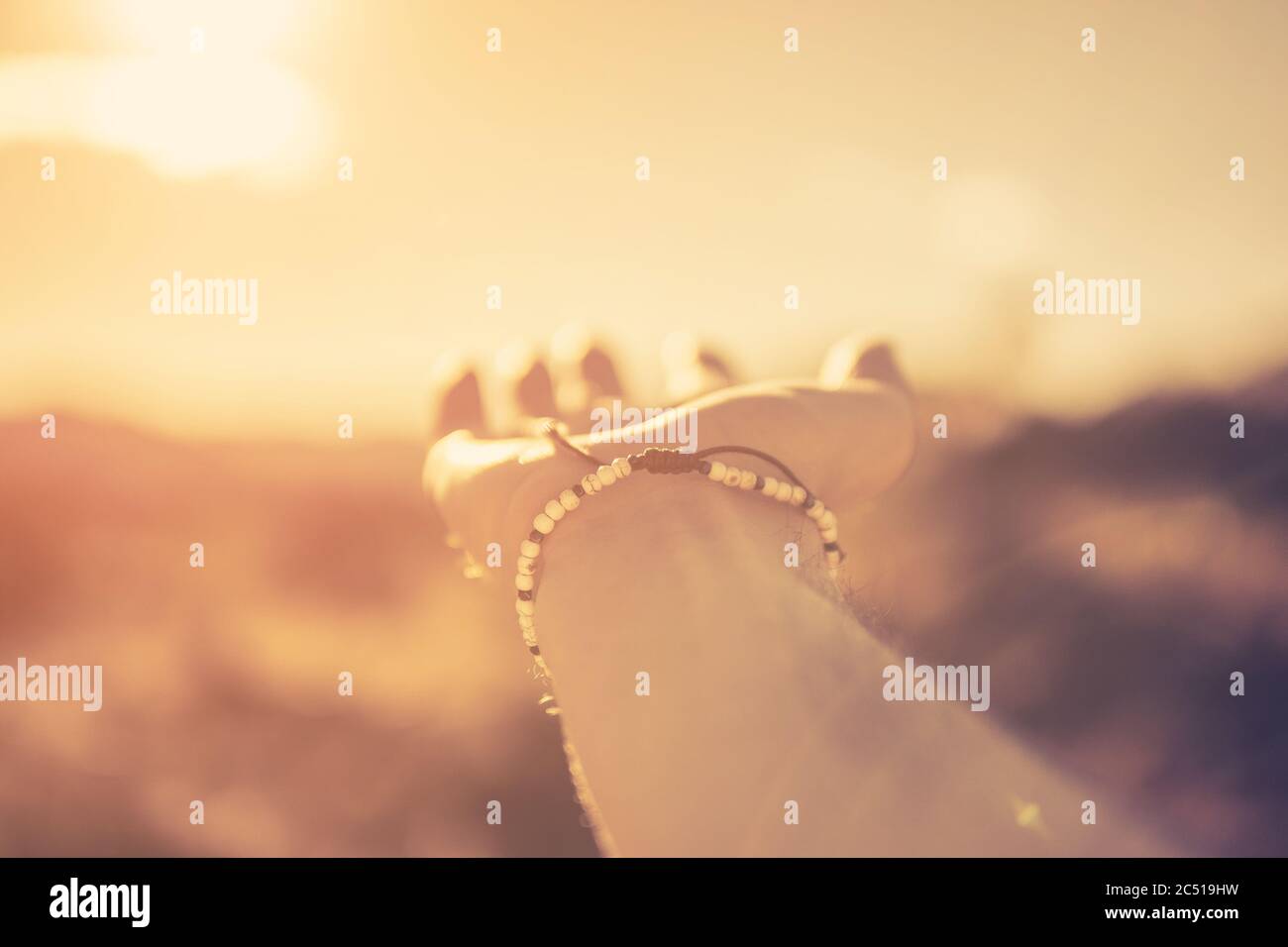 hand reaches for the sun. the warmth of the sun. concept to catch your ...