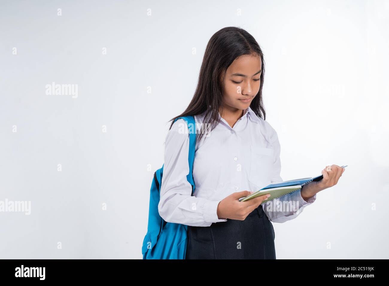 girl junior high school student using tablet pc over white background ...