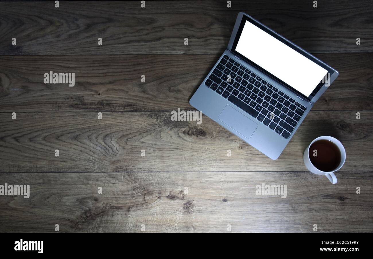 Laptop with a cup of coffee on wooden office desk Stock Photo - Alamy