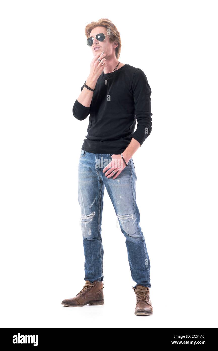 Thoughtful young musician artist smoking cigarette looking up having ...