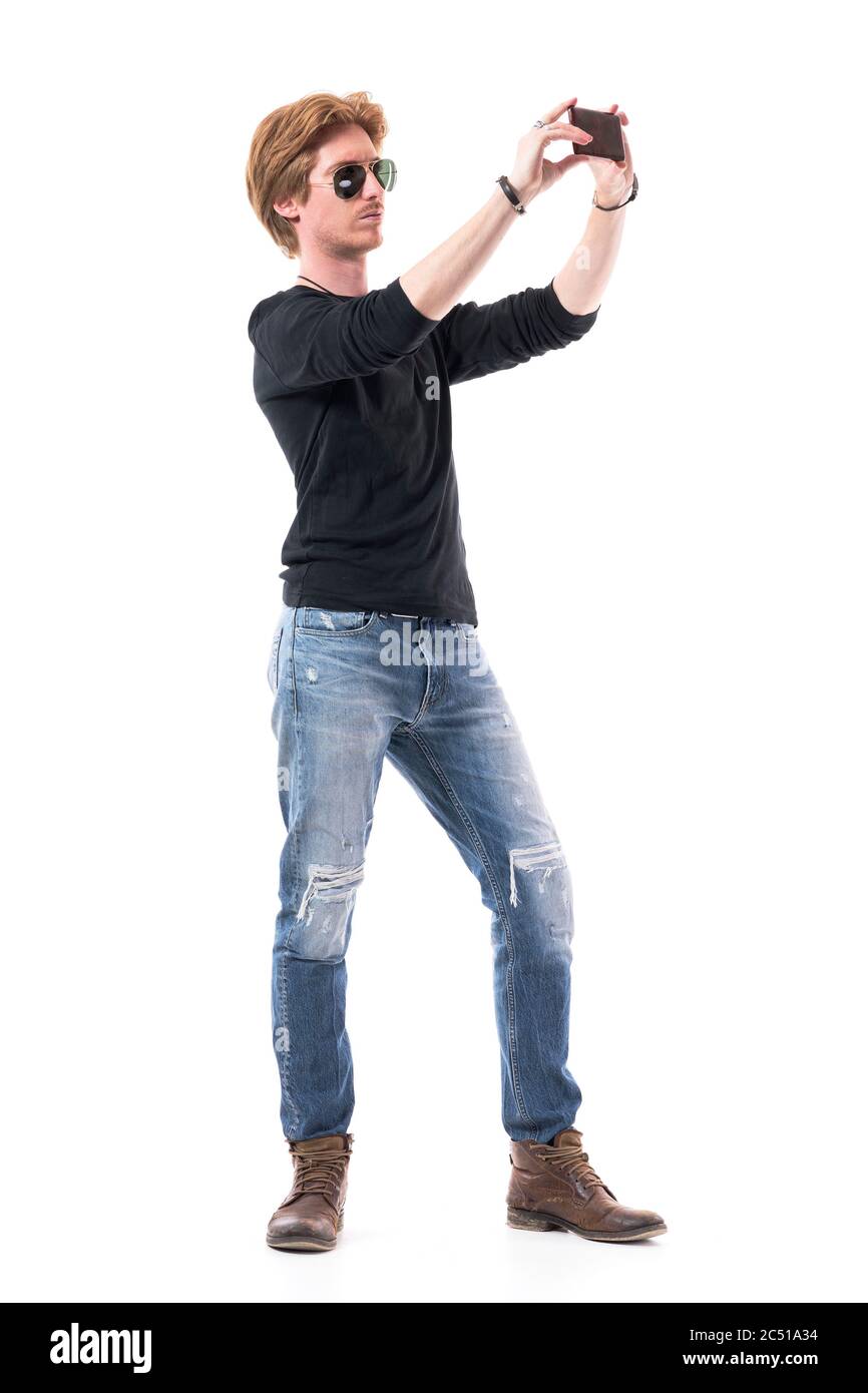 Young handsome confident man recording video using smart phone. Full ...