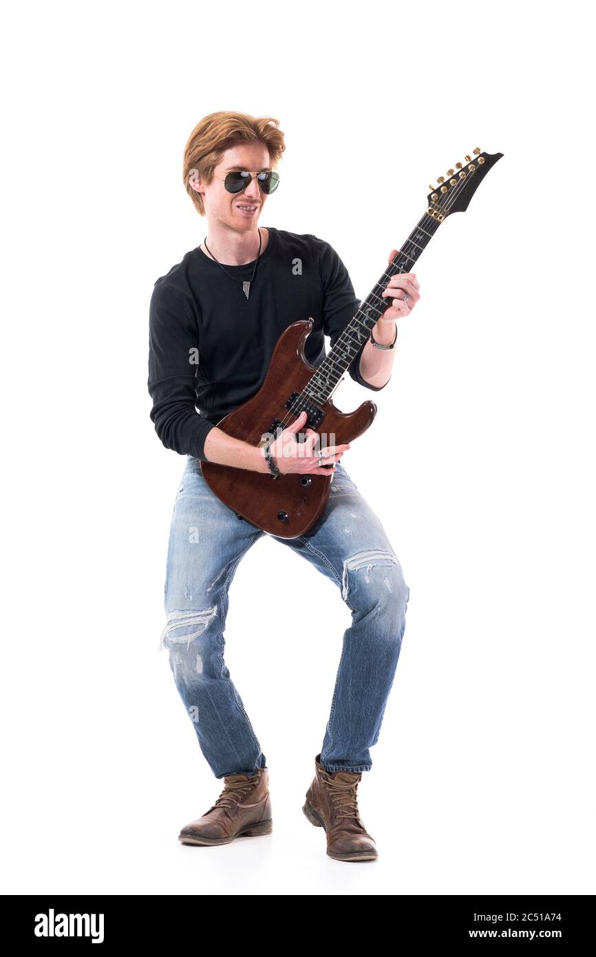 Young happy smiling handsome stylish rocker playing electric guitar ...