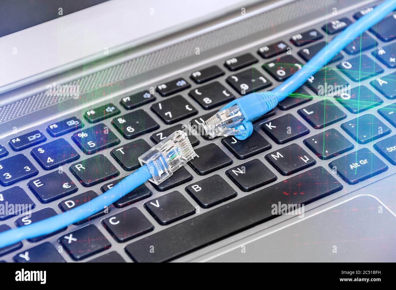 Two cables on computer keyboard symbolizing connection to cyberspace ...