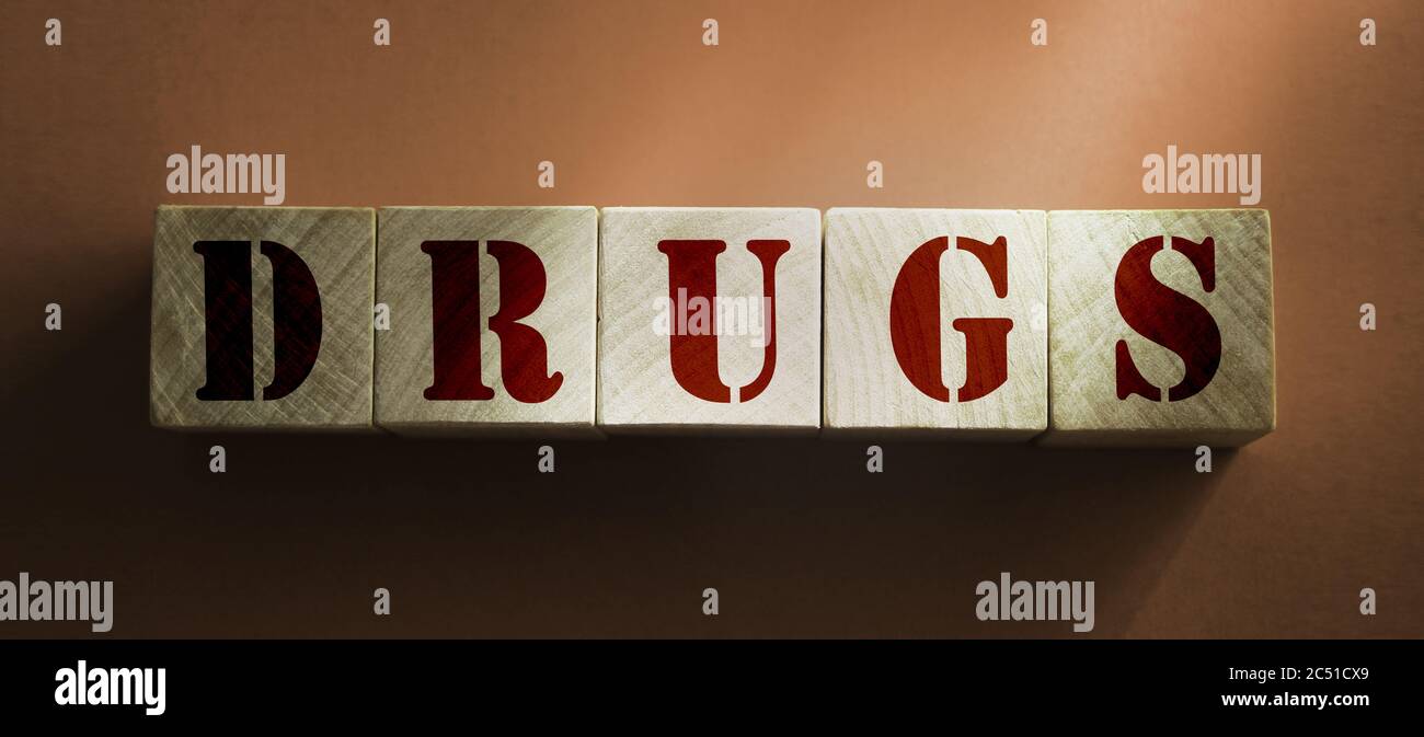 Wooden cube with a hashtag and the word Drugs isolated on white ...