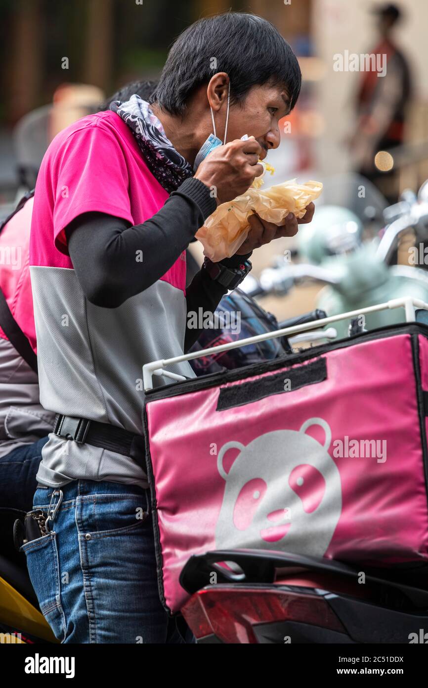 Food Panda delivery man eating with face mask during covid 19 pandemic ...