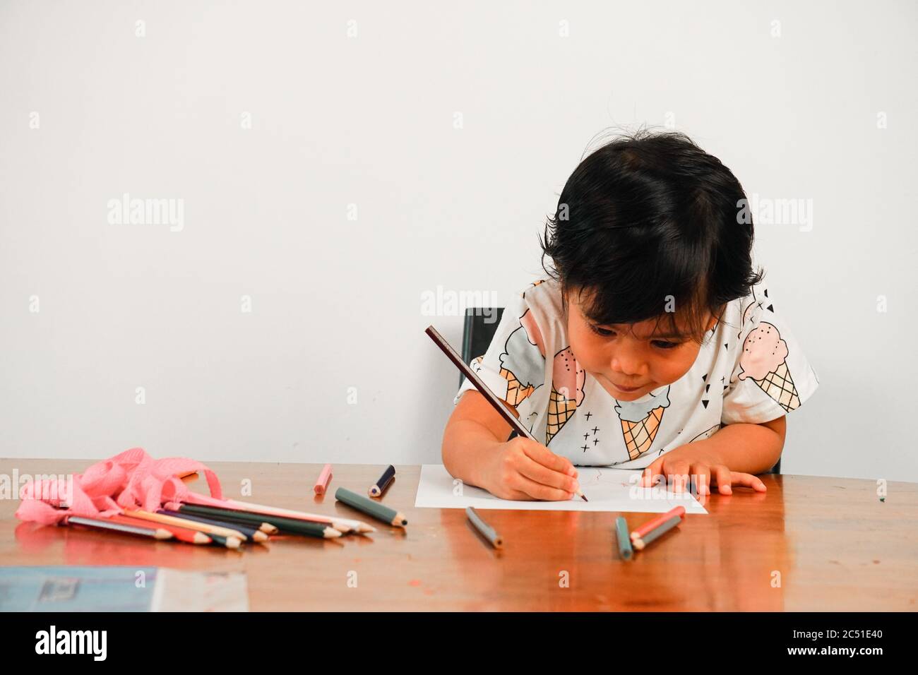 Cute little girl child concentrated drawing at home. Learning and ...