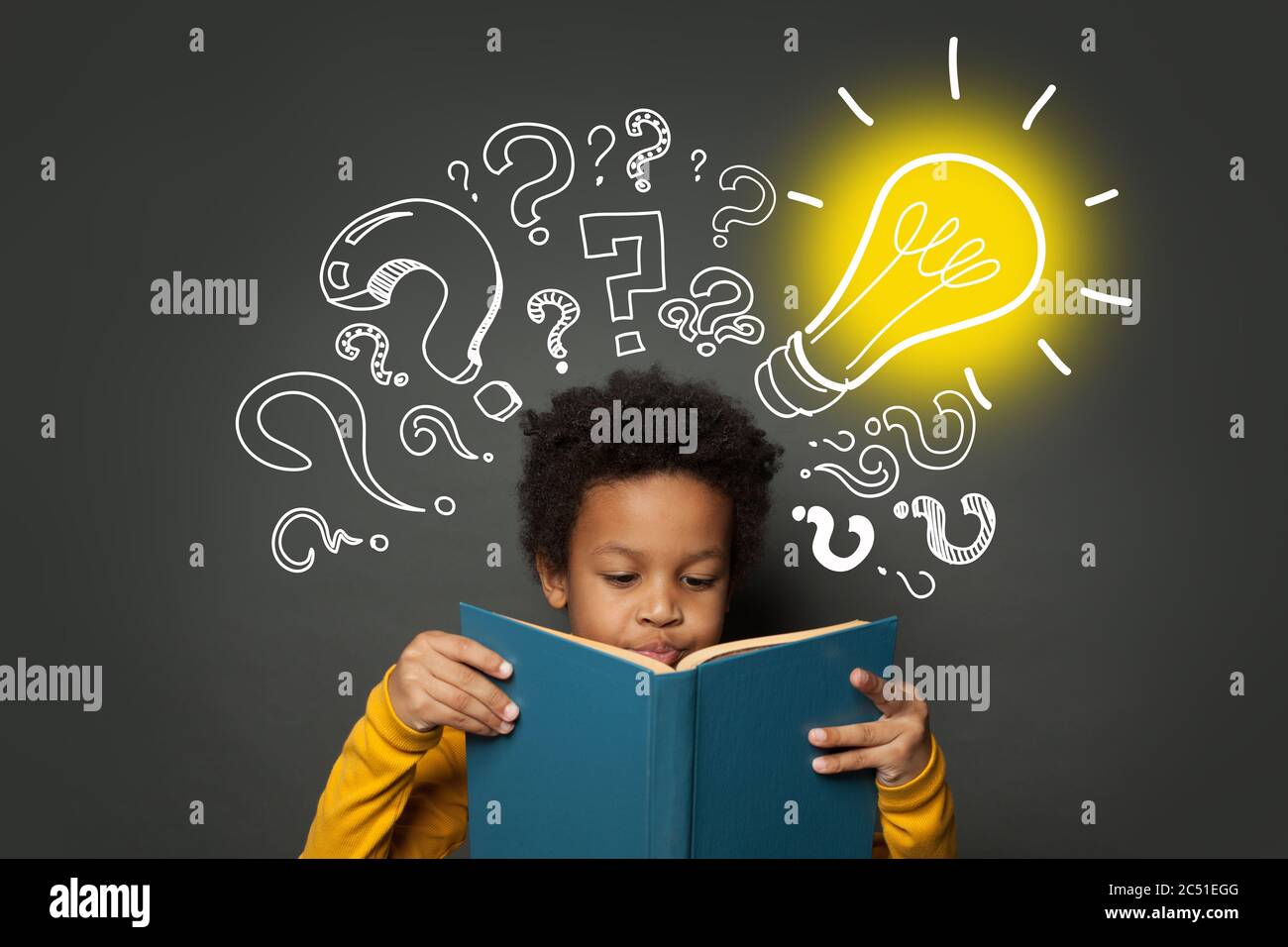 Intelligent black kid student reading book and having idea ...