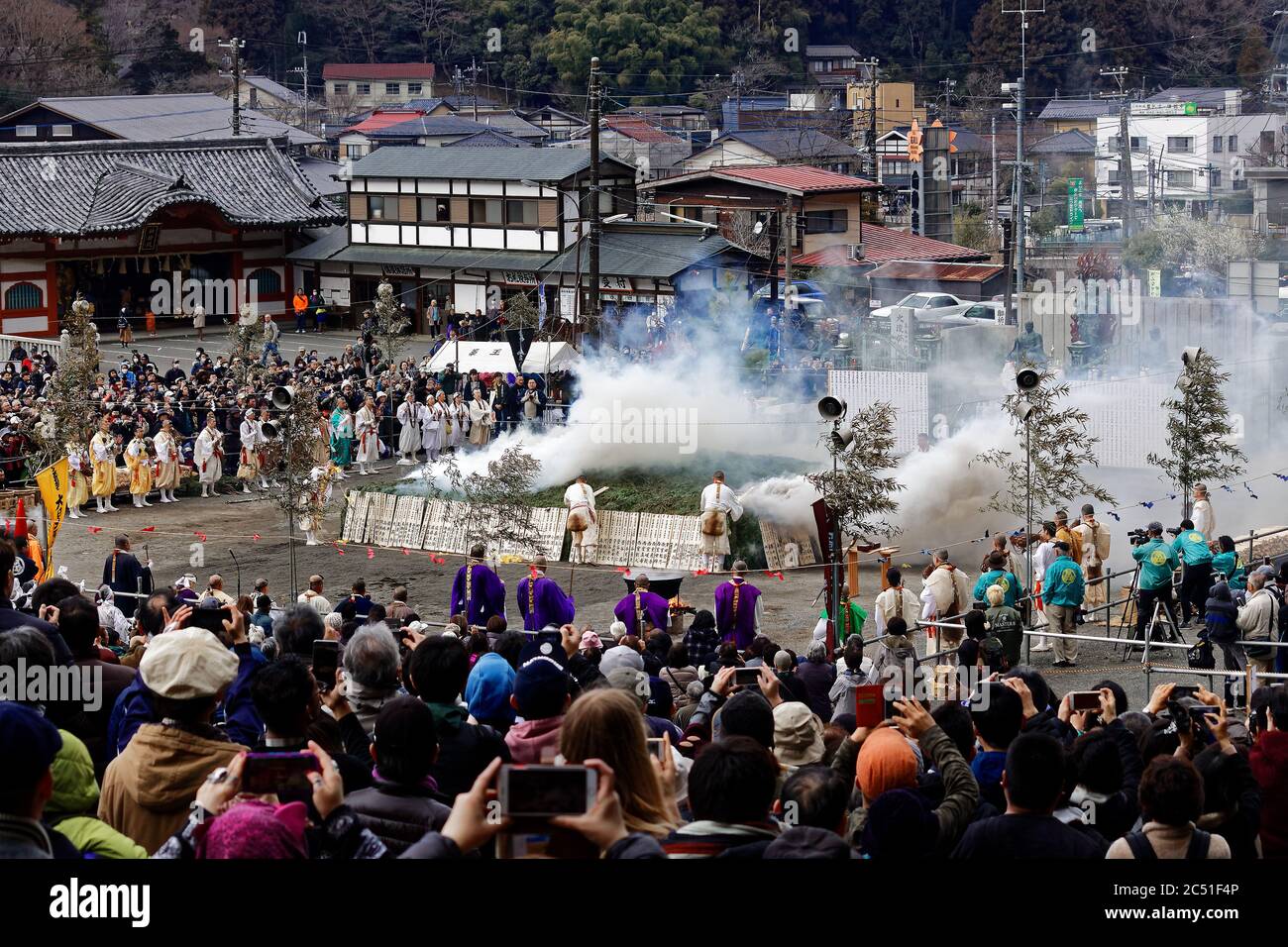 Smoke begins to billow from the pile of green kindling that will fuel ...