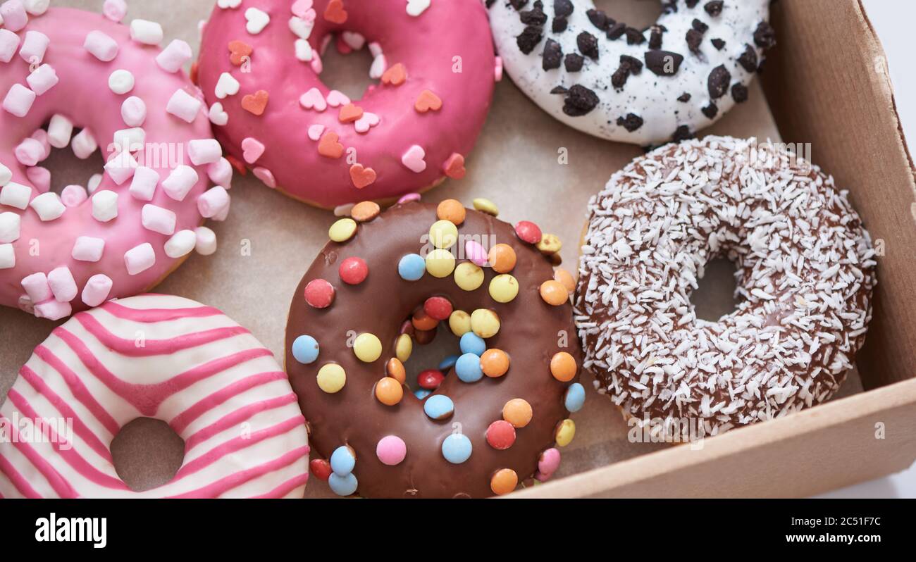 several donuts in a cardboard box close up Stock Photo - Alamy