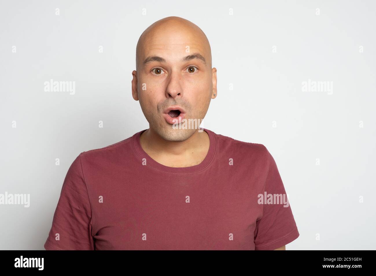 Shocked caucasian guy. Funny bald man isolated on grey background Stock ...