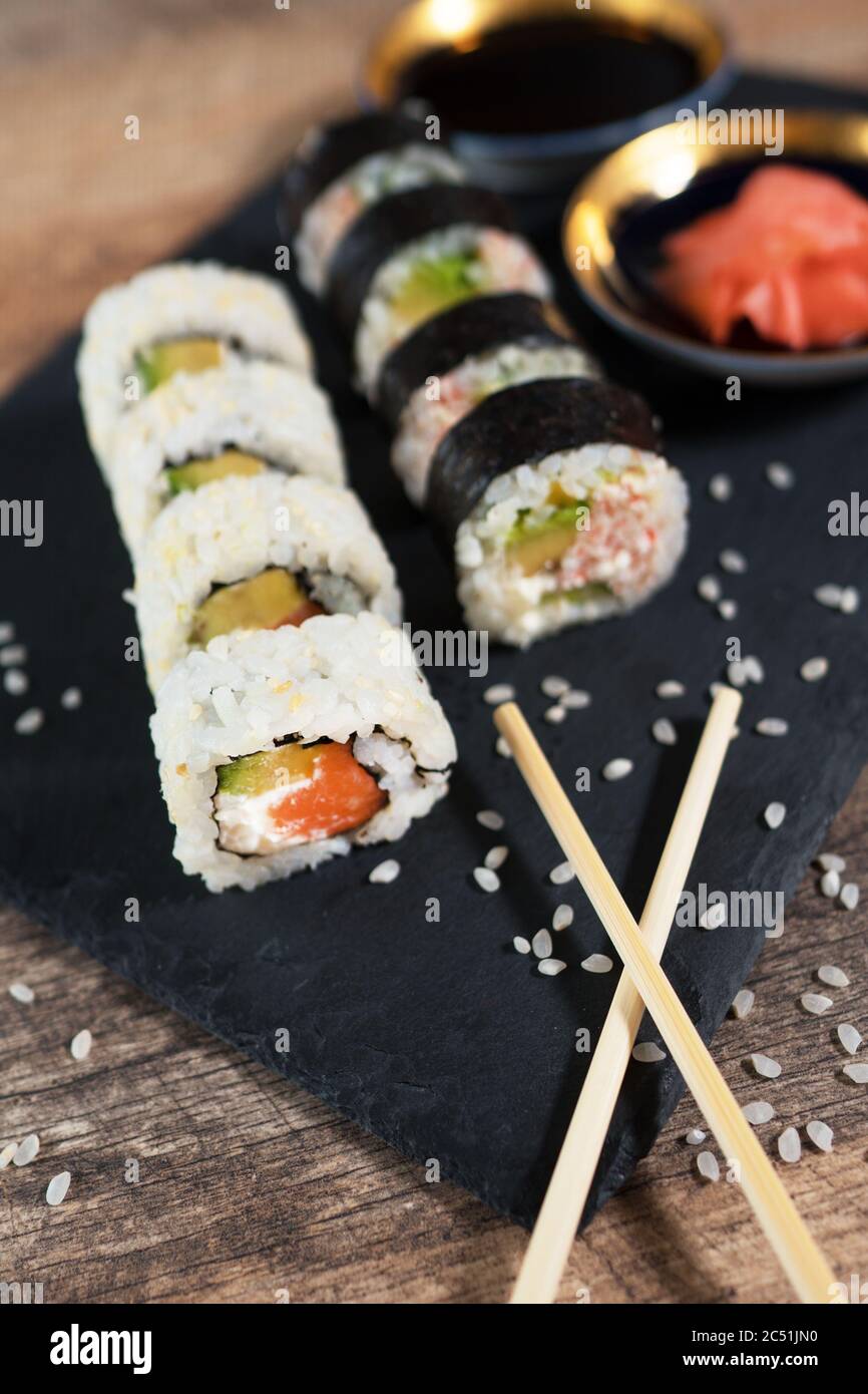 Sushi roll set on the black plate. Japanese food Stock Photo - Alamy