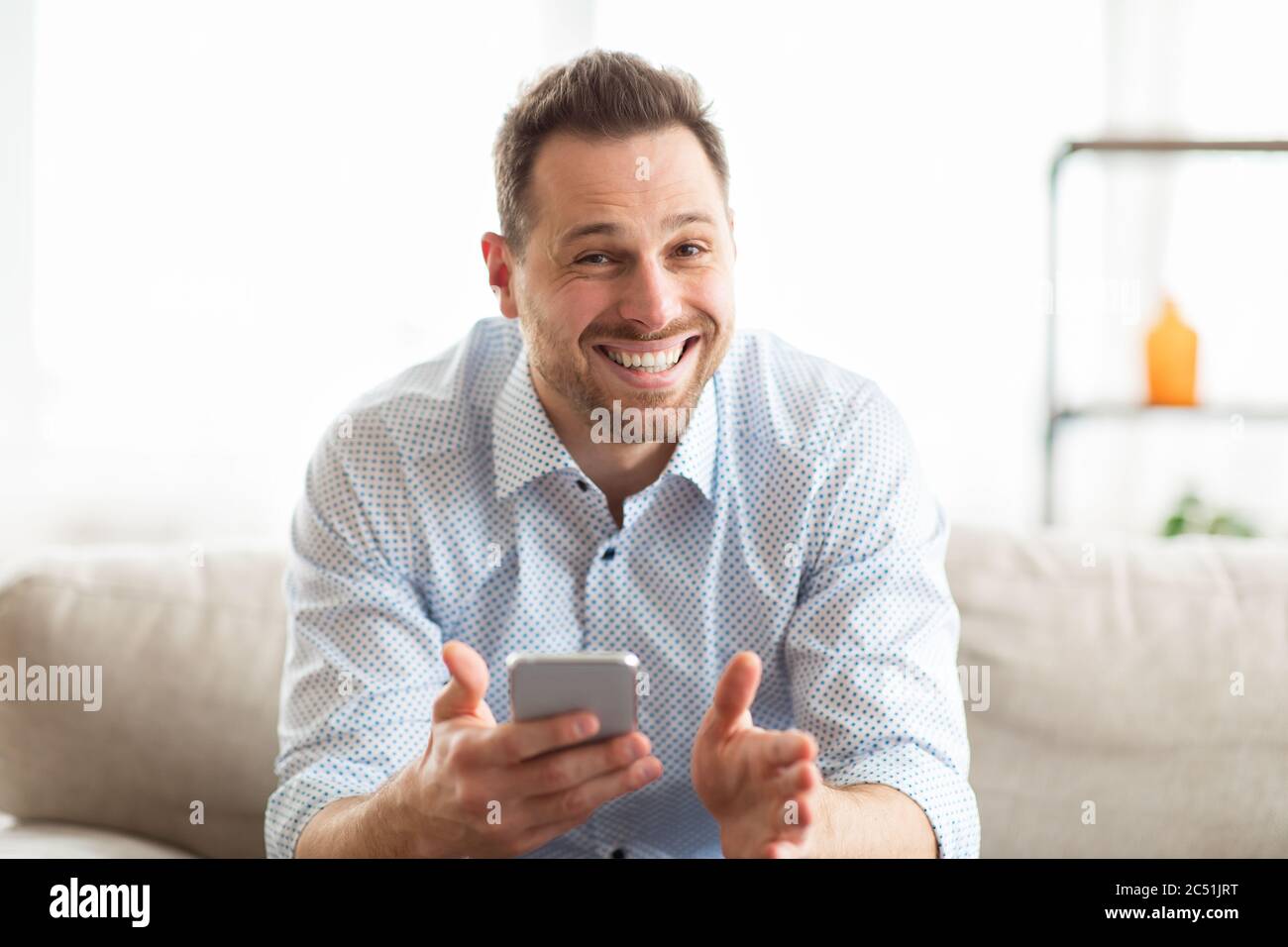 Excited young businessman using cell hi-res stock photography and ...