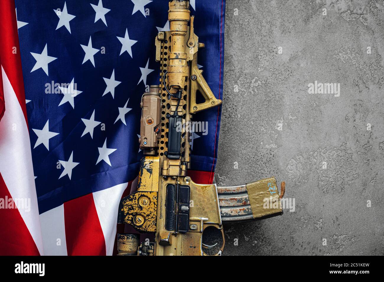 U.S. battle flag and assault rifle near the wall. close up Stock Photo ...