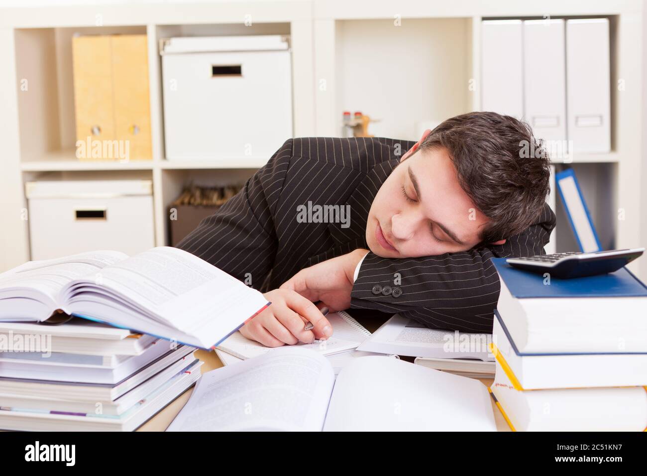 Tired businessman falls asleep at his desk hi-res stock photography and ...