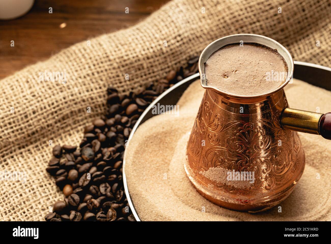 Turkish coffee prepared in sand with turk Stock Photo - Alamy