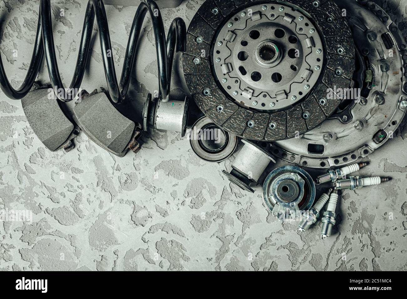 Car parts on grey textured concrete background Stock Photo - Alamy
