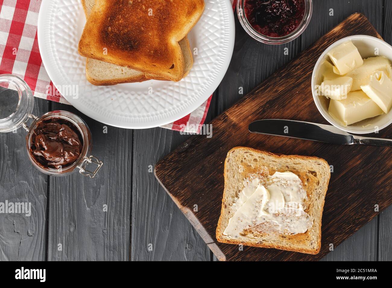 Simple breakfast. Toasted bread covered with butter Stock Photo - Alamy
