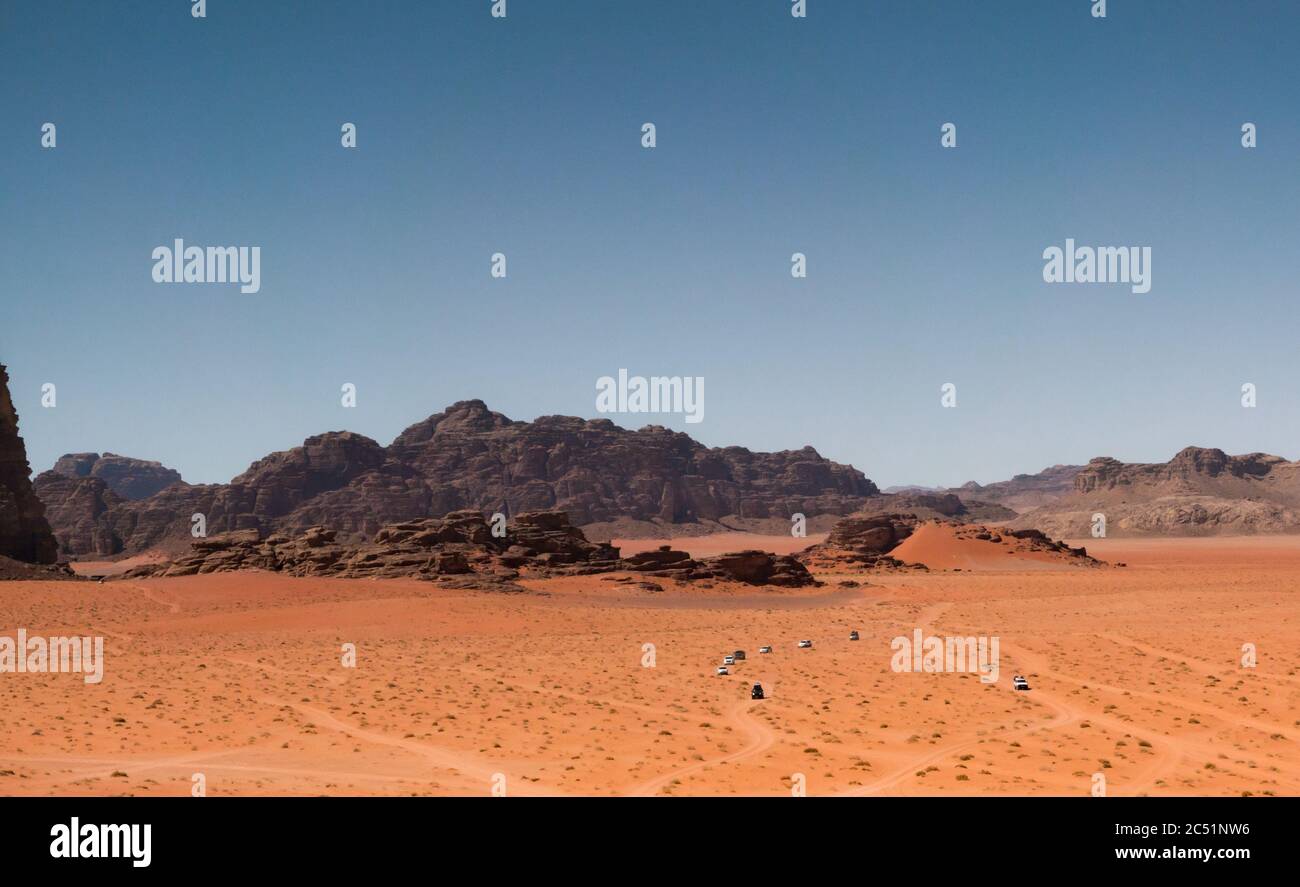 Convoy of 4x4 vehicles crossing Wadi Rum desert valley, Jordan, Middle ...