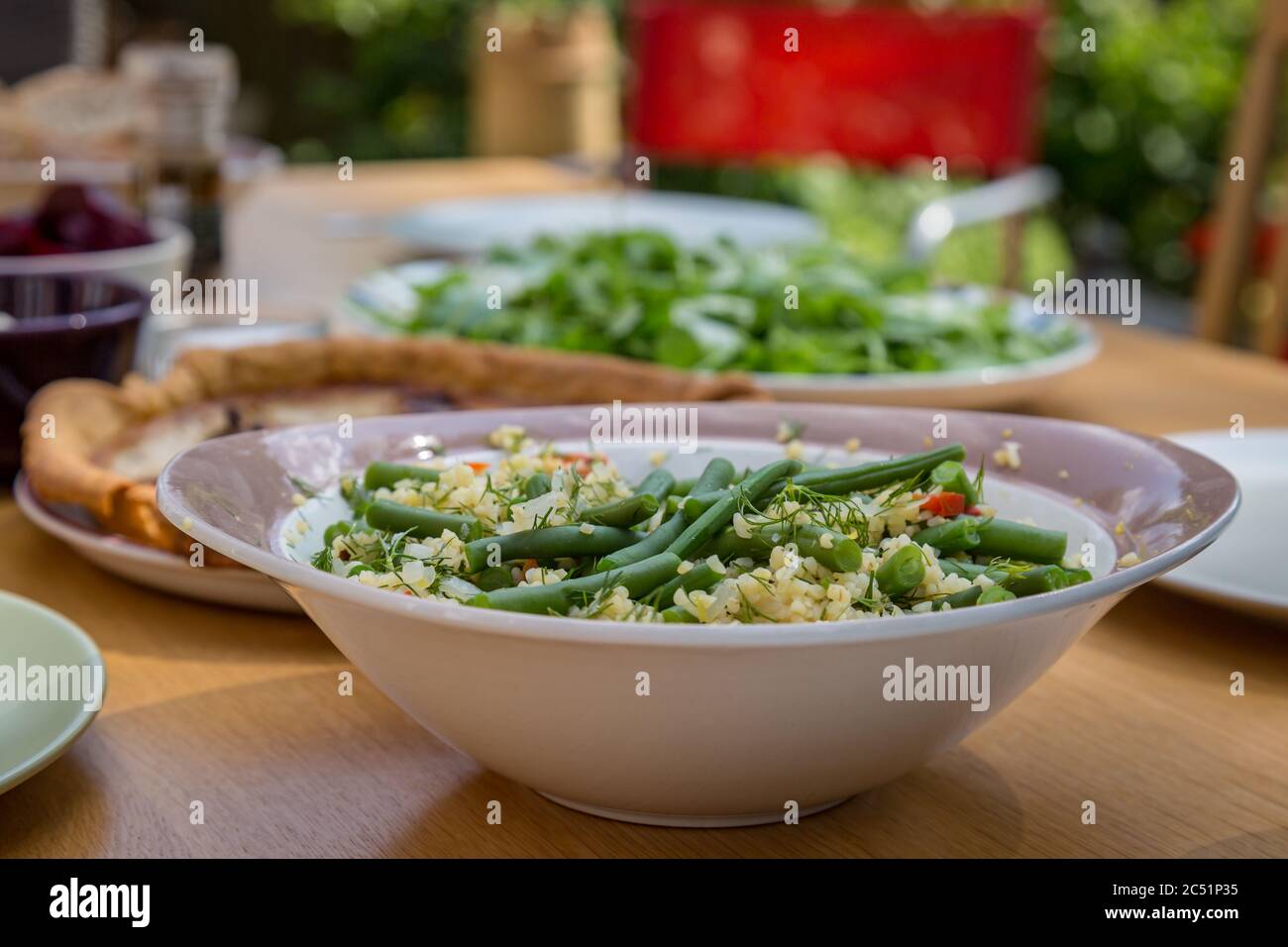 An outdoor dining table set for a summer lunch Stock Photo - Alamy