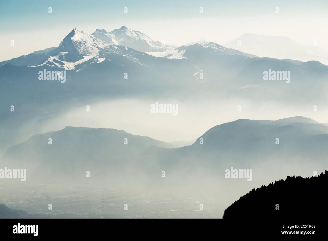 Spectacular view of mountain ranges silhouettes and fog in valleys ...