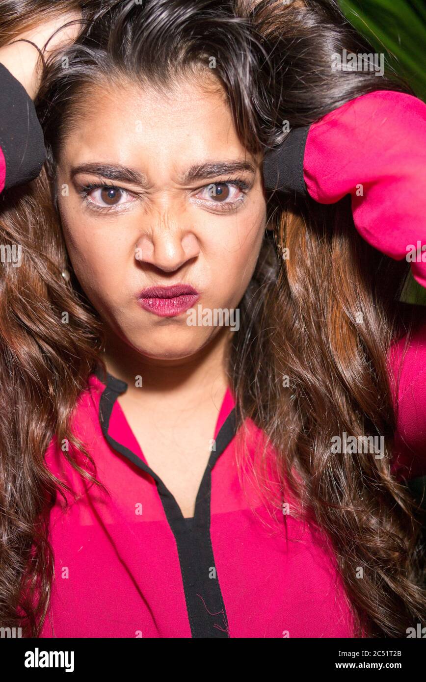 Face of stressed young Indian businesswoman looking angry Stock Photo ...
