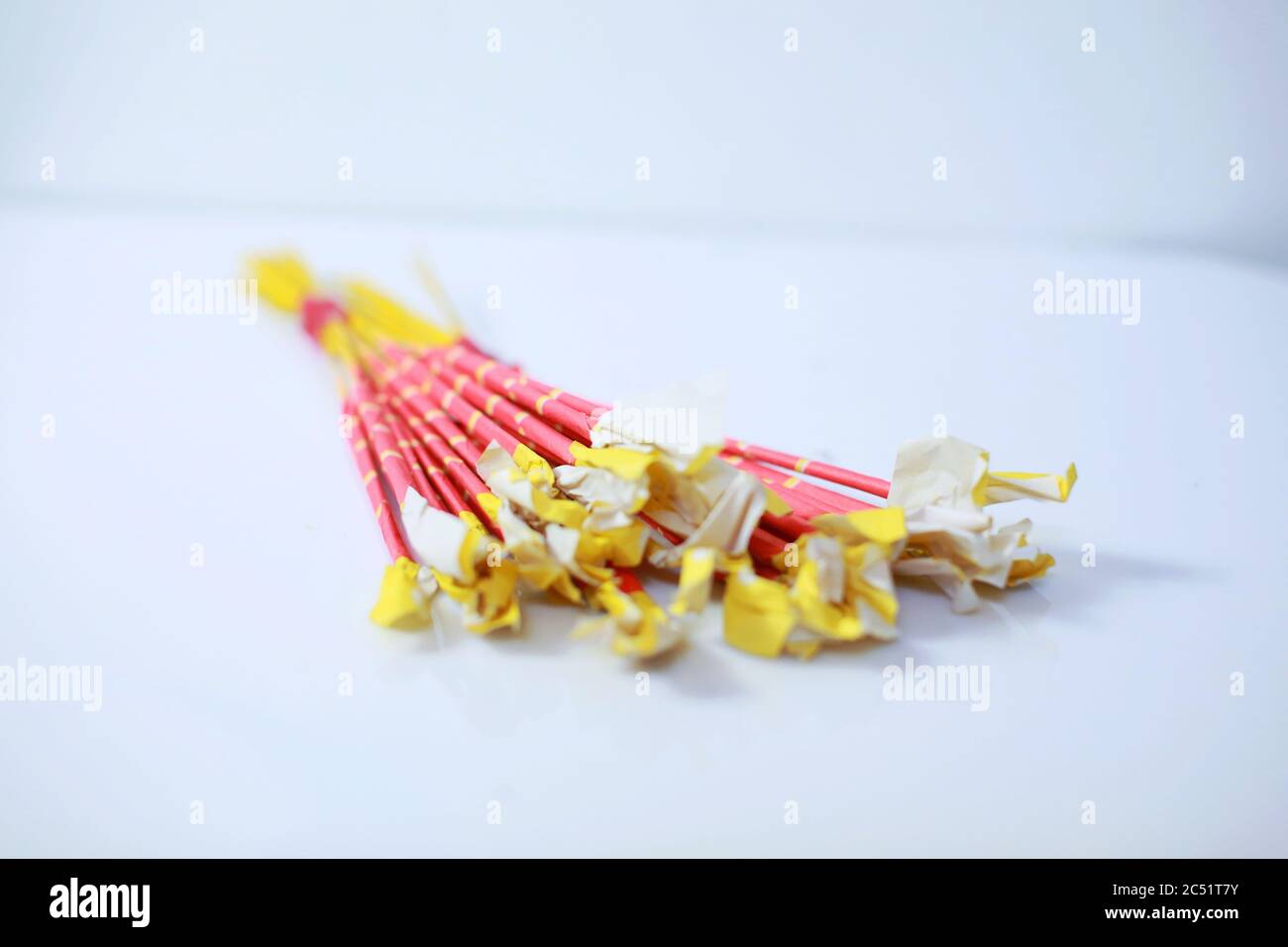 Closeup shot of red and yellow fireworks isolated on a white background ...