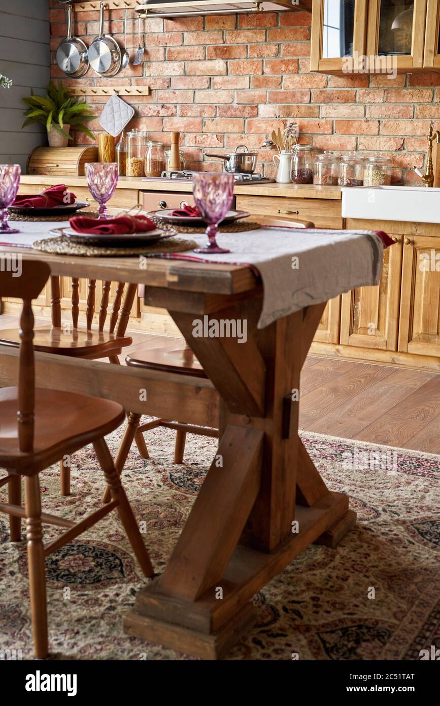 Serving for dinner on kitchen table. Warm kitchen background interior ...
