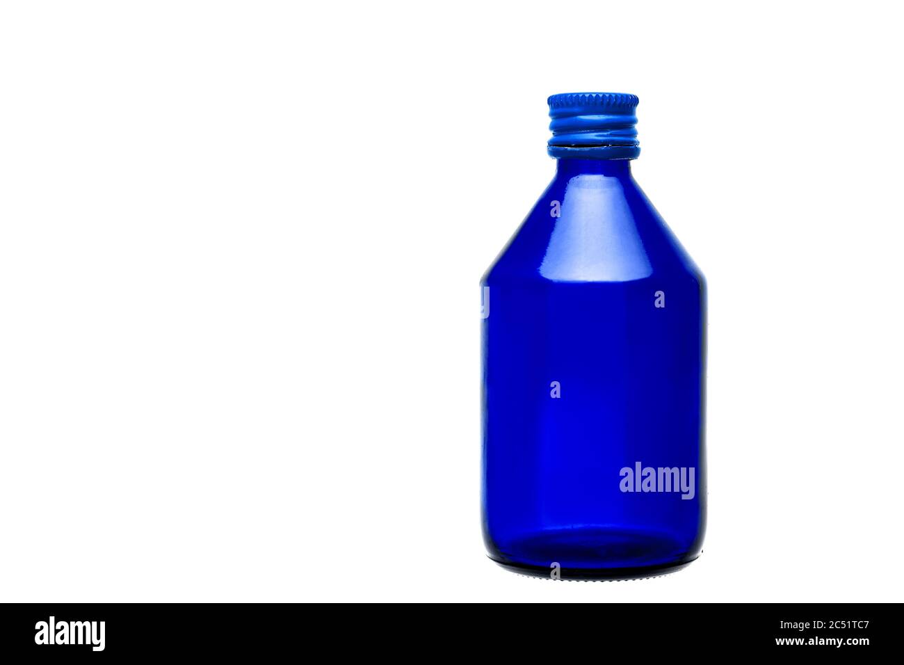 blue glass bottle with medical alcohol for disinfection with a metal ...