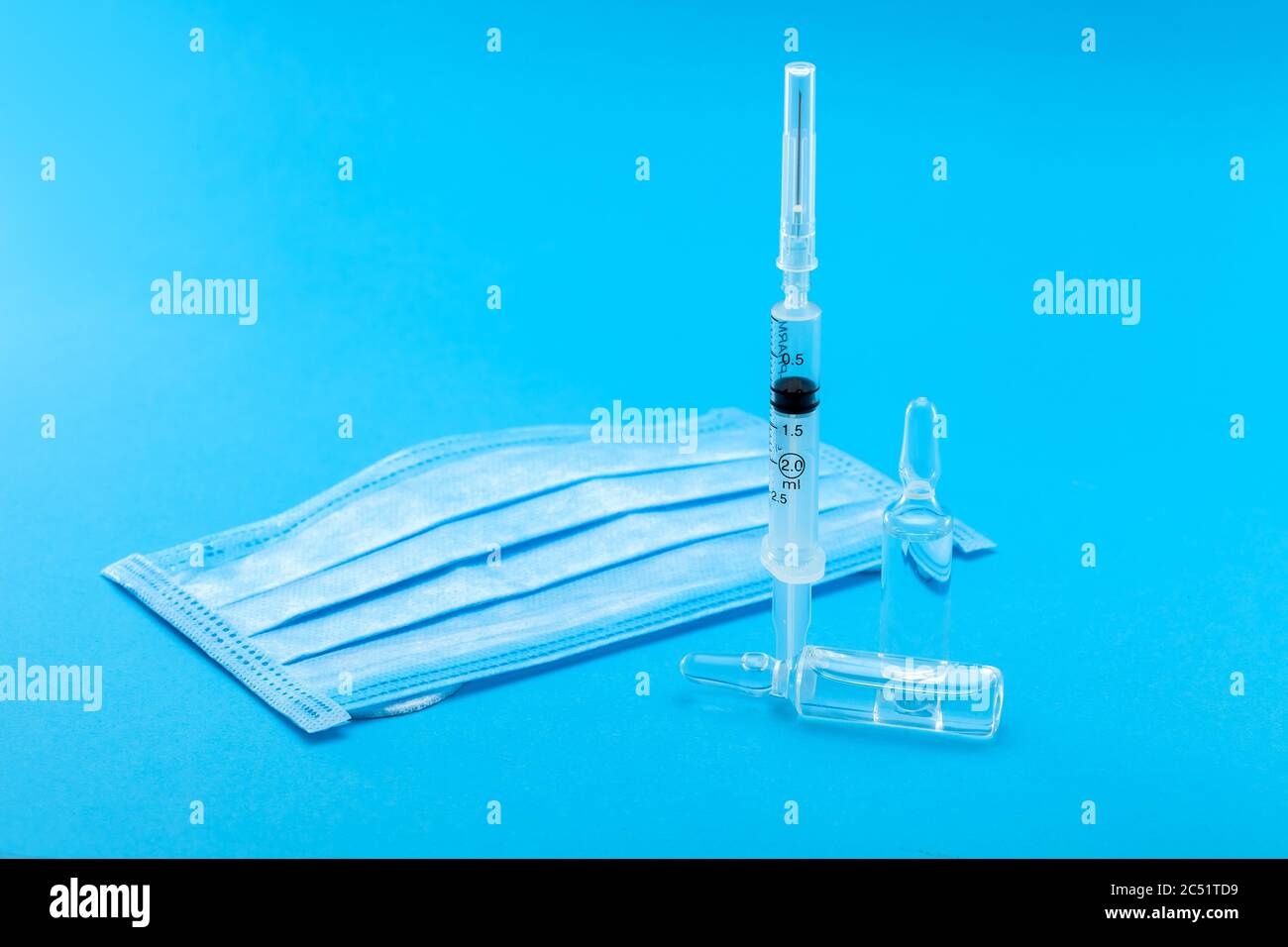 medical mask and syringe with ampoules for injection of a viral disease ...