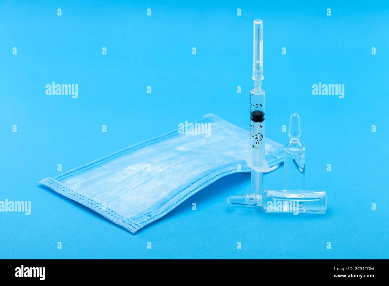 medical mask and syringe with ampoules for injection of a viral disease ...