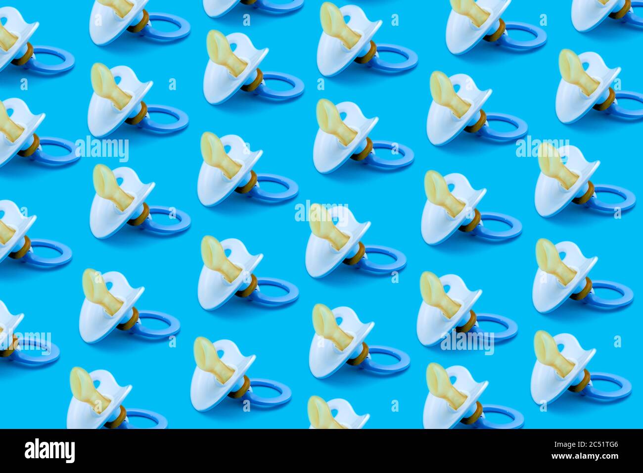 a blue pacifier pattern of soft silicone objects isolated on blue ...