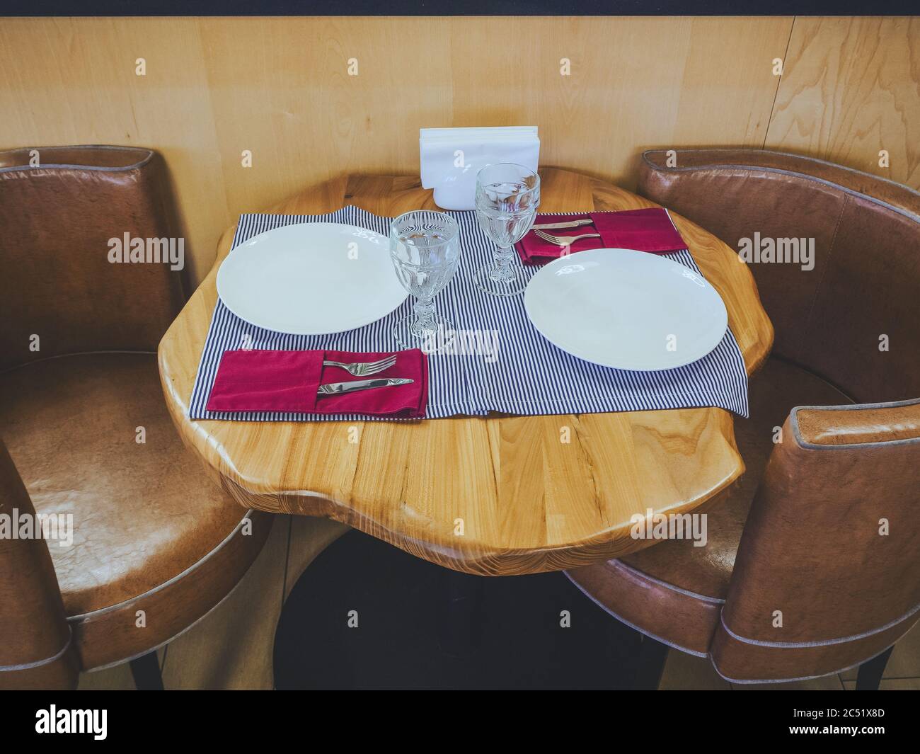 Small table with irregular shape wooden table top with cutlery for two ...