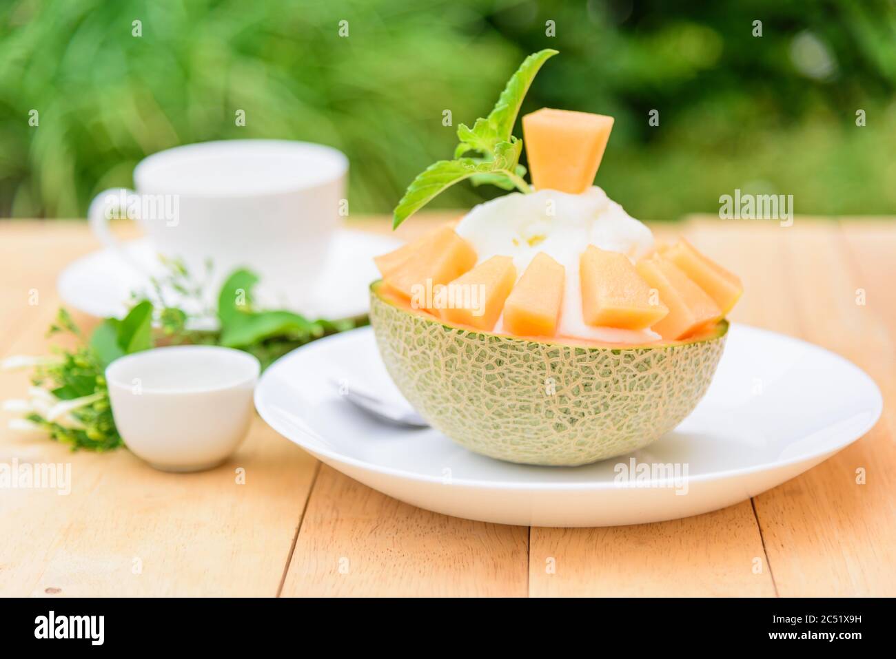 Melon Bingsu with Sweetened Condensed Milk on wood table Stock Photo ...
