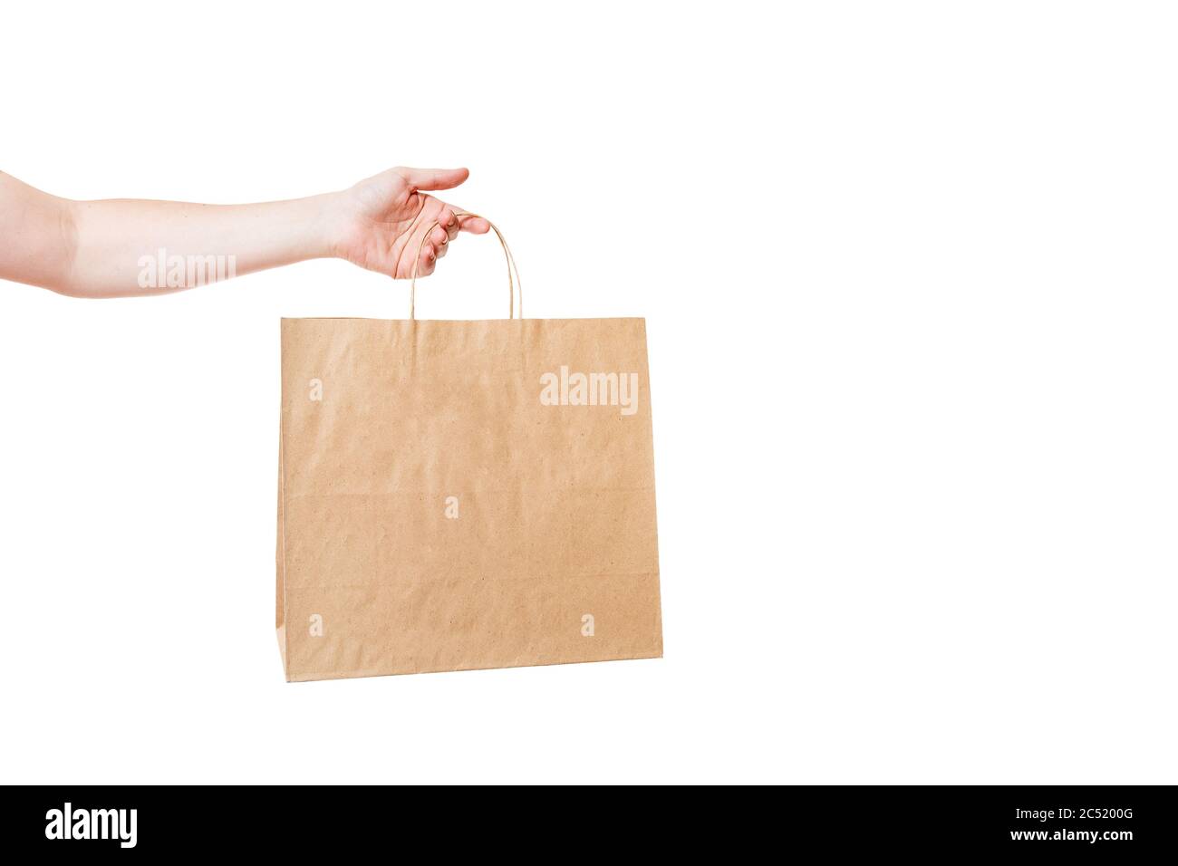 hand holds brown eco friendly craft paper bag, label packet for grocery ...