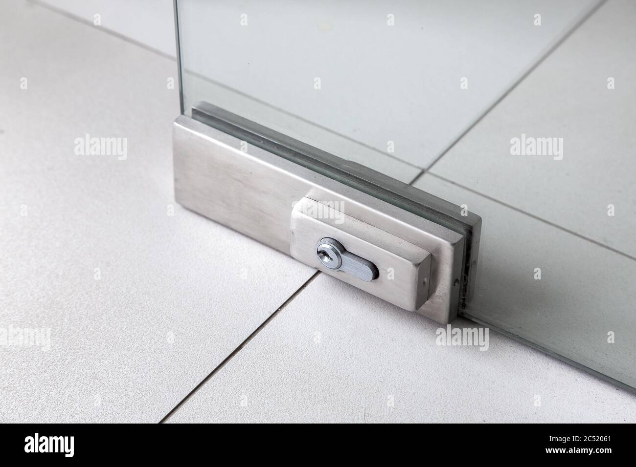 The lock on the glass door, the metal mechanism of locking the doors ...