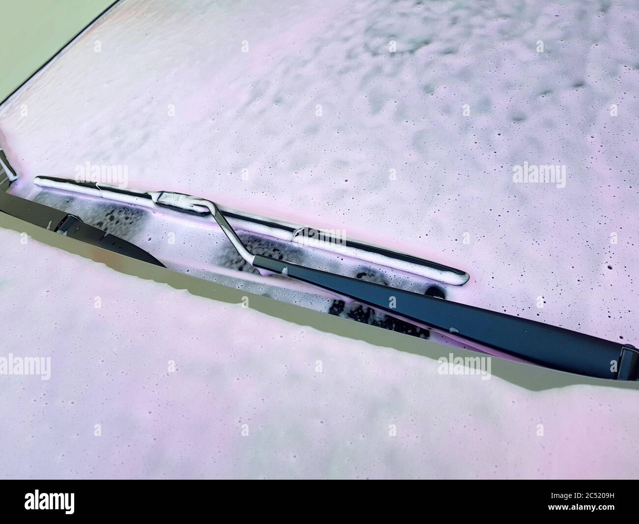 Windshield with a wiper blades coated with active washing foam for ...