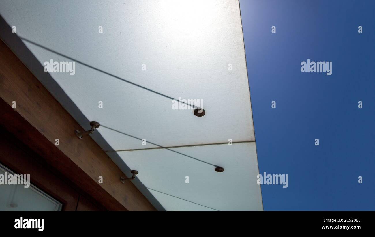 glass matt visor at the entrance to the facade of the building fixed ...