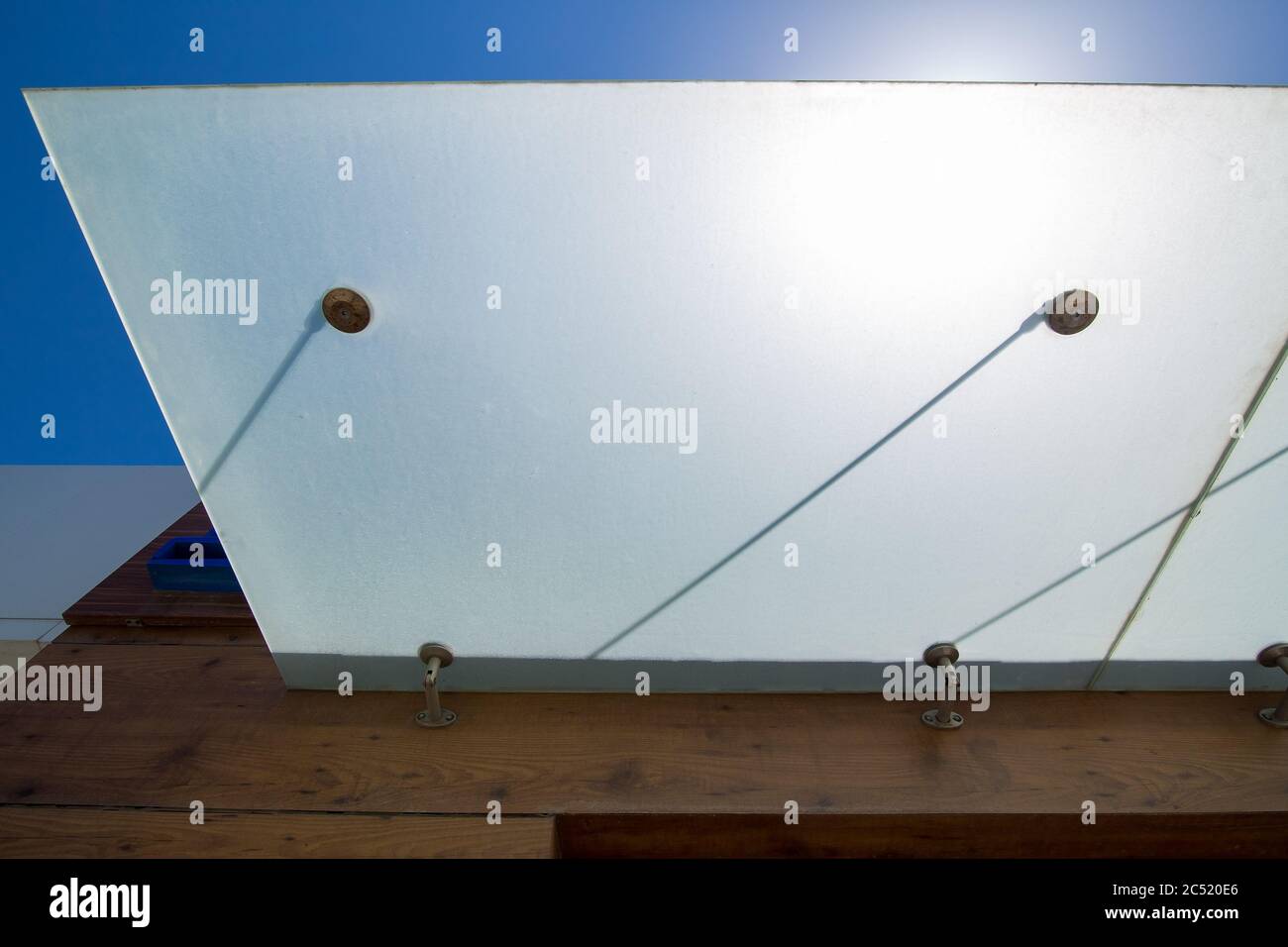 glass matt visor at the entrance to facade of building fixed with metal ...