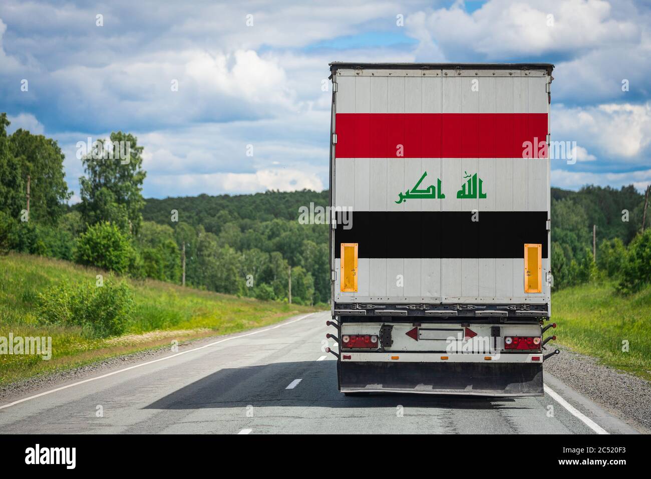 A truck with the national flag of Irak depicted on the back door ...