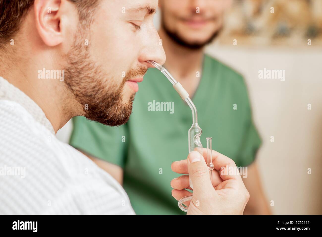 Man receiving nasal inhalation by essential oil in nose at spa Stock ...