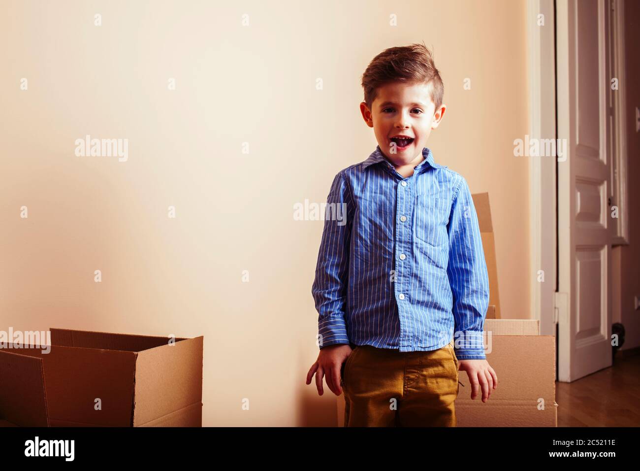little cute boy in empty room, move to new house. home alone among ...