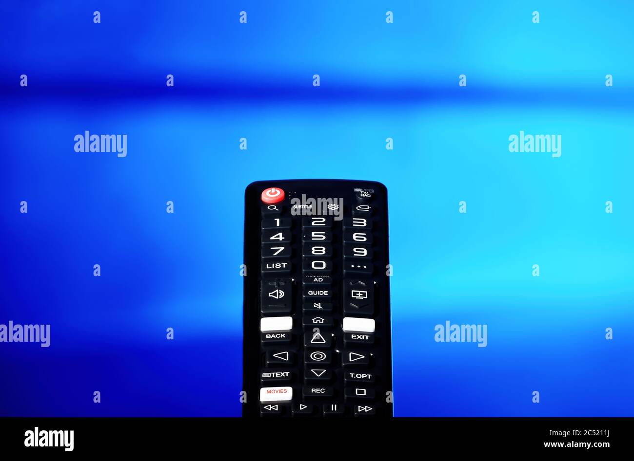 TV remote control pointing towards the television screen. Switching ...