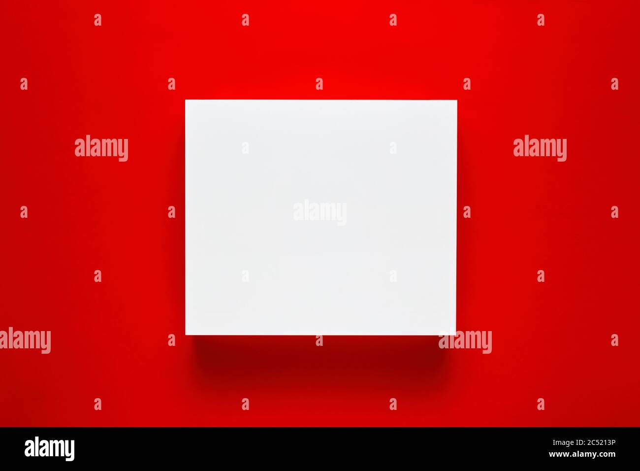 White blank square shape or frame on red background. Mockup for product ...