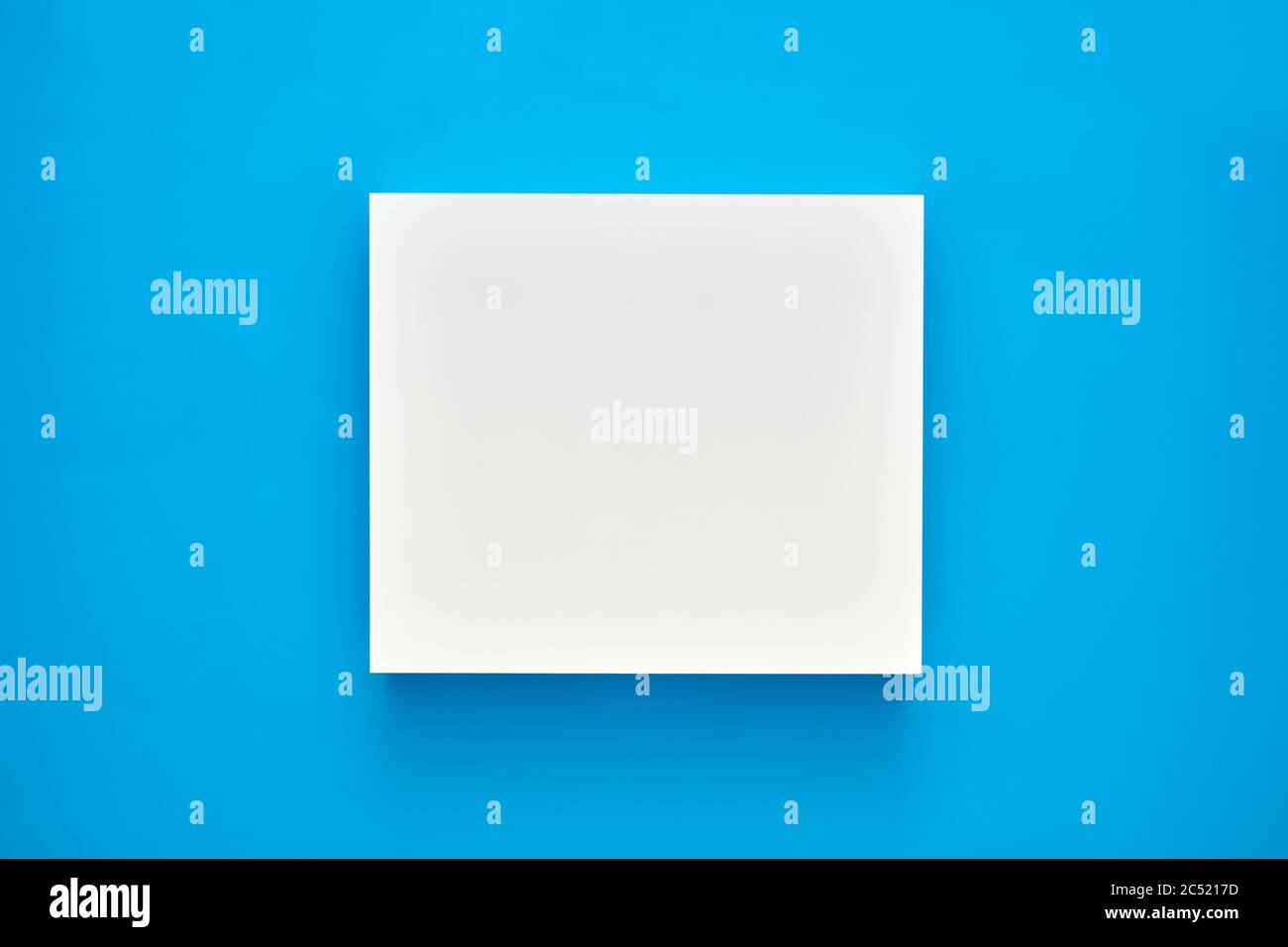 White blank square shape or frame on blue background. Mockup for ...