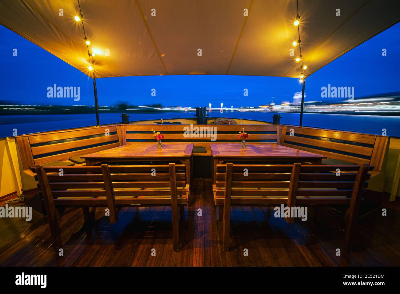 Interior of table and benches in a boat lightening at night Stock Photo ...