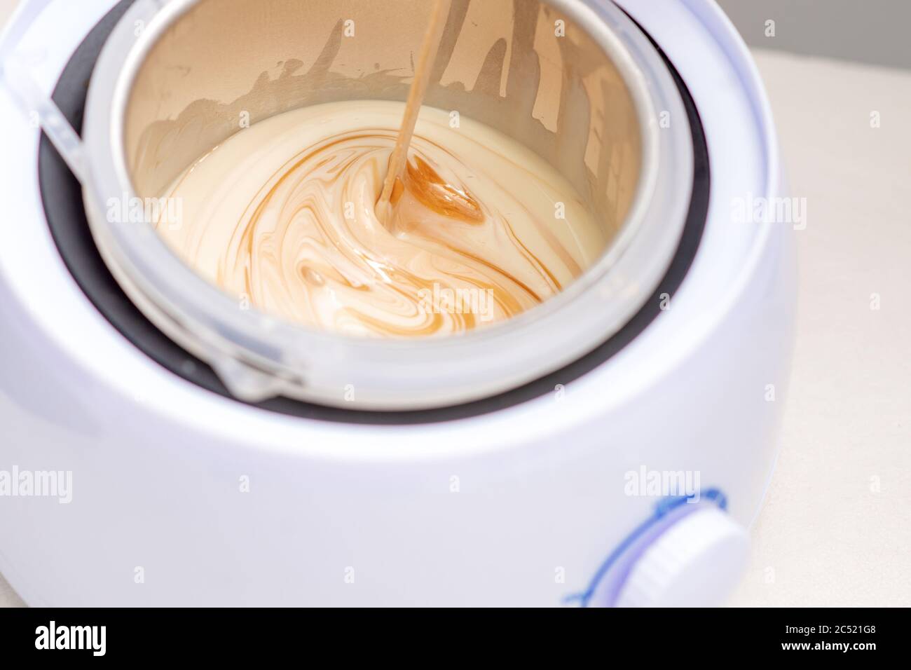 Wax depilation heating hi-res stock photography and images - Alamy